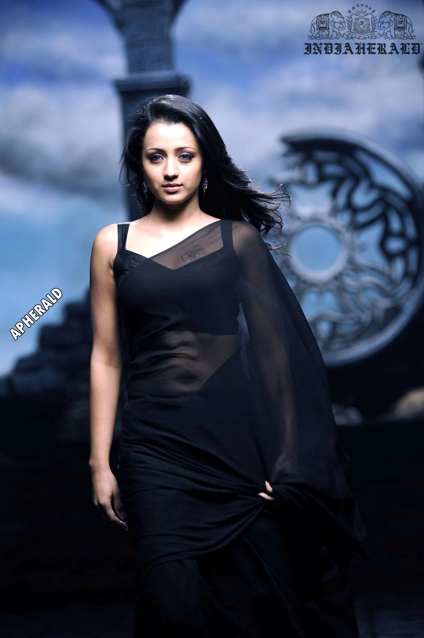 Trisha tempts our mood by exposing her navel and waist in B