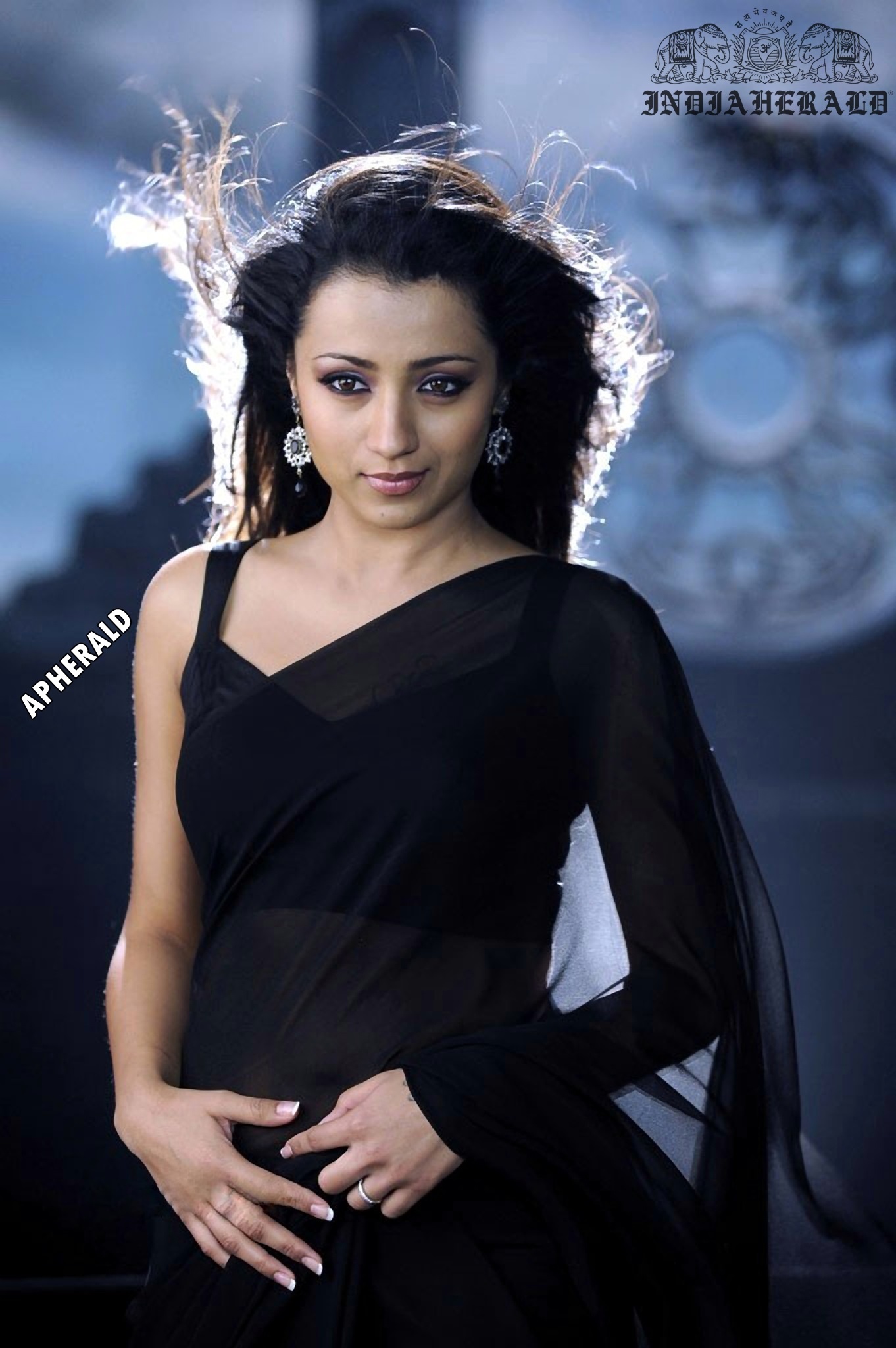 Trisha tempts our mood by exposing her navel and waist in B