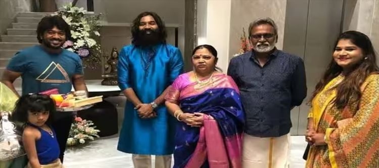 A photo of actor Dhanush attending a puja at his sister Kar