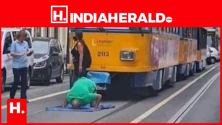 A Muslim immigrant is praying on the tram line making Passe